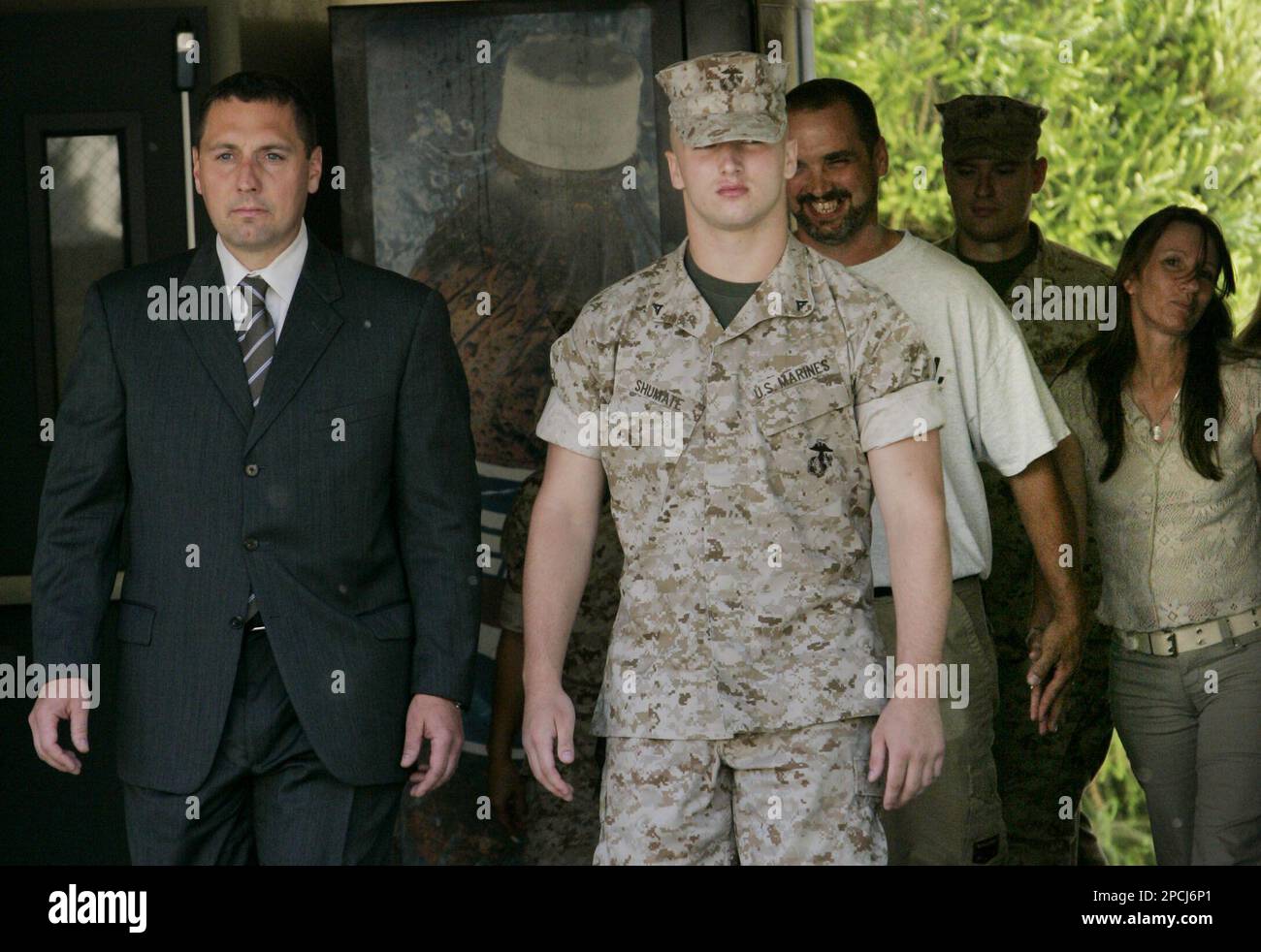 U.S. Marine Lance Cpl. Jerry Shumate Jr., center, walks with his ...