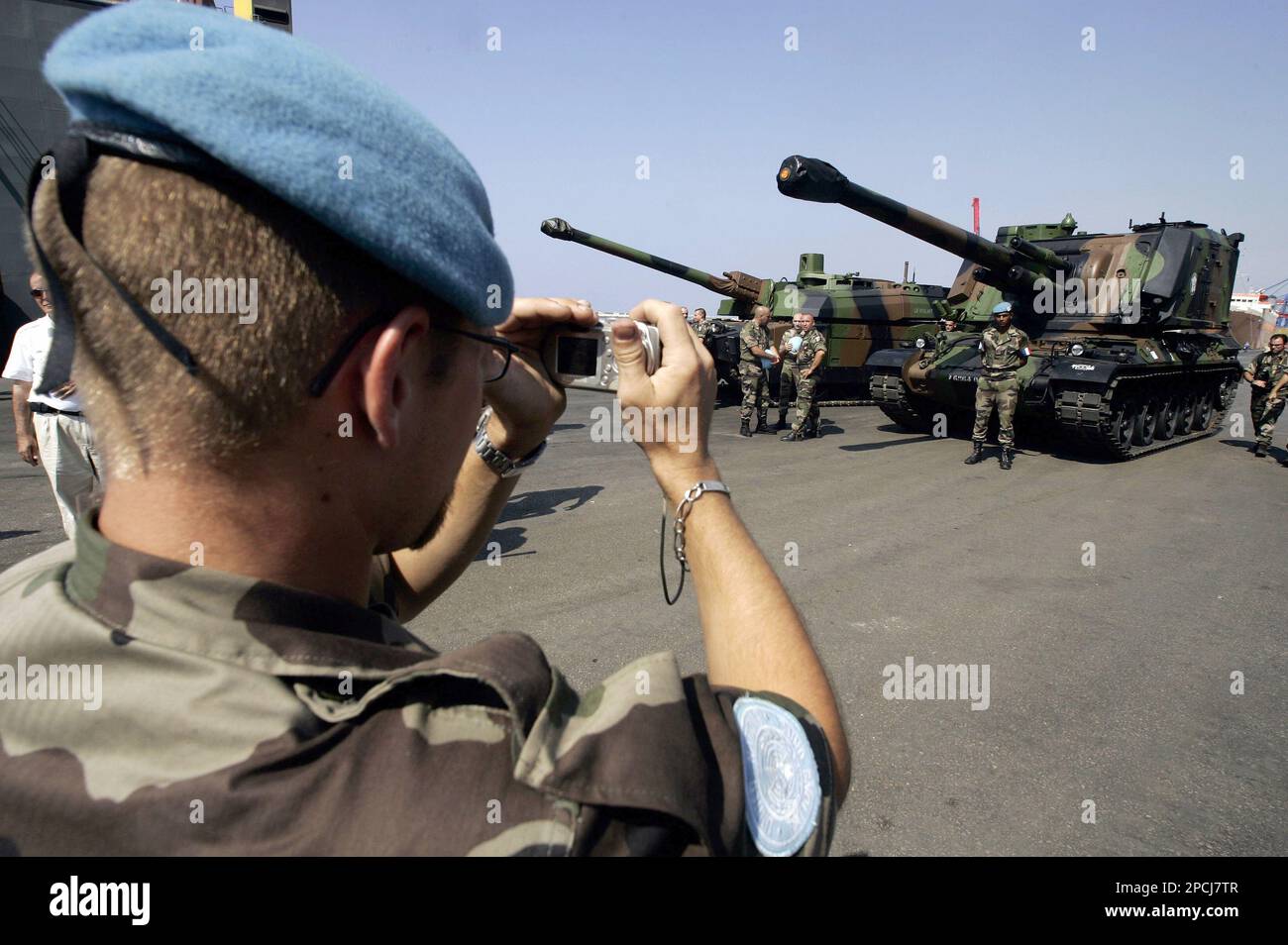 A U.N. French peacekeeper takes a picture of his colleagues standing in ...