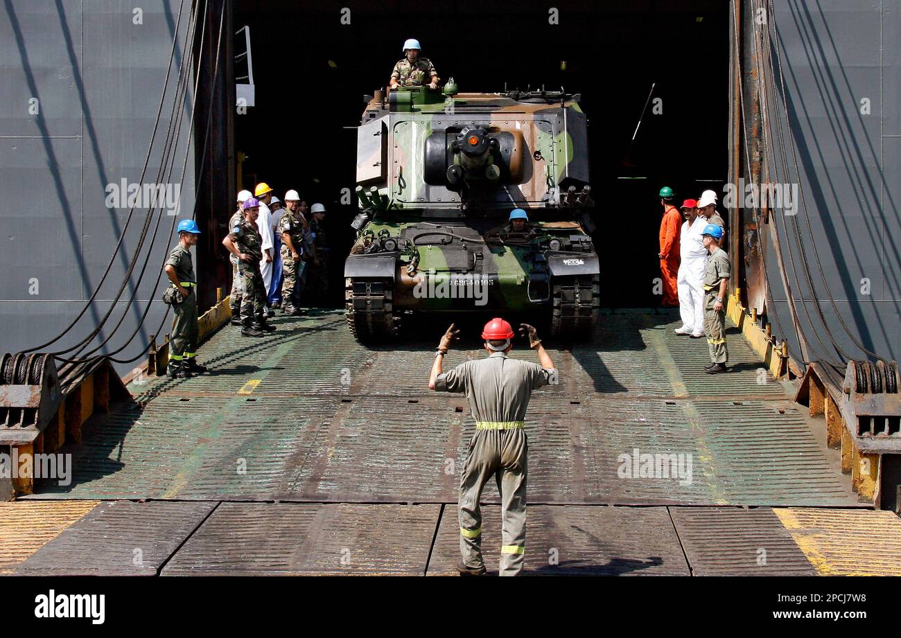 A ship worker directs a French U.N. peacekeeper driving a AUF1 ...