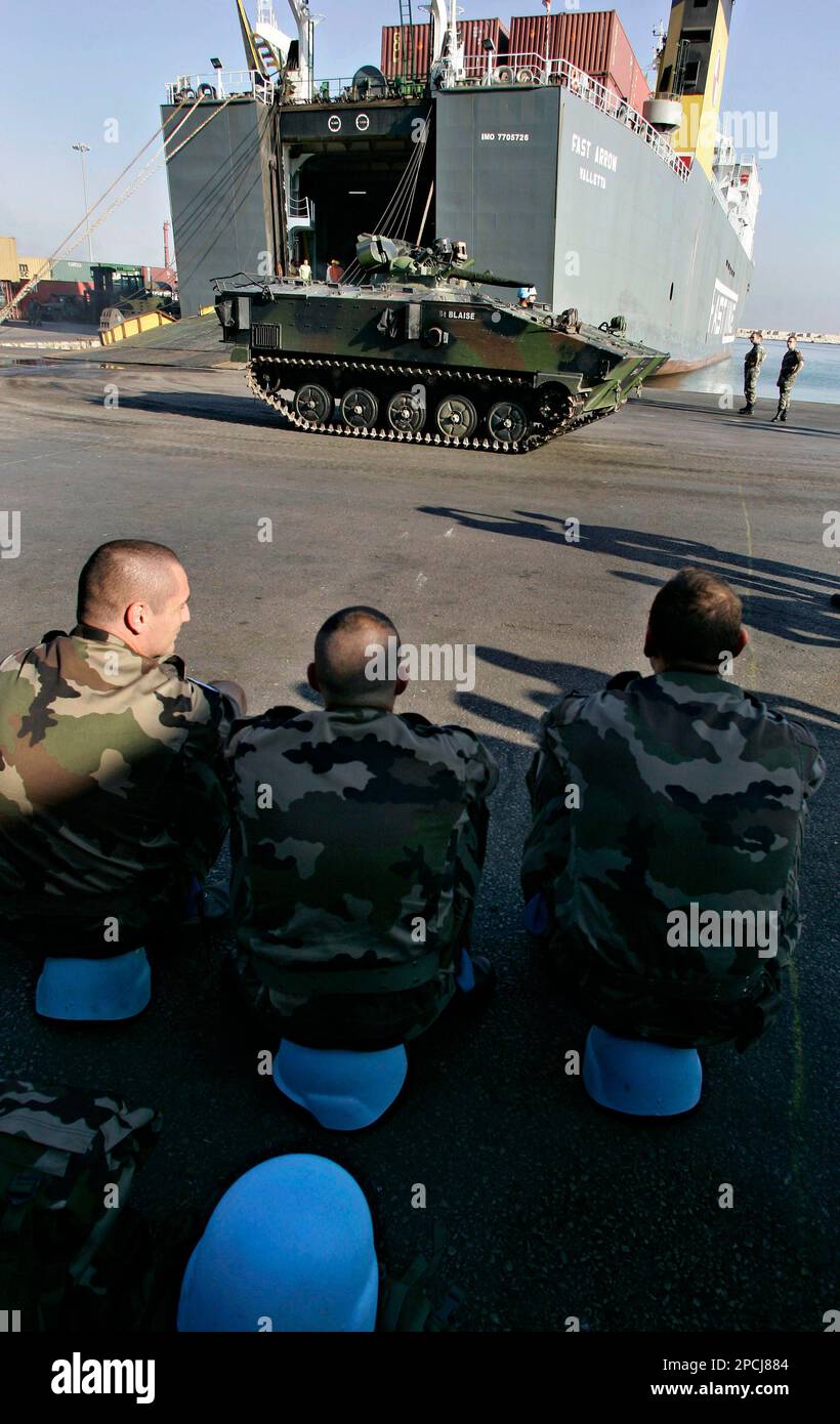 French U.N. peacekeepers rest on their blue helmets as armored ...