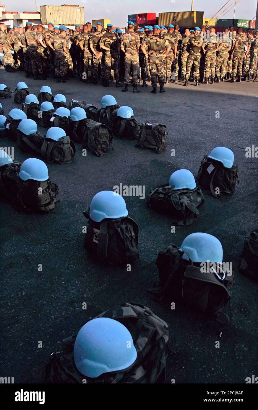French U.N. peacekeepers' belongings and blue helmets lie at the dock ...