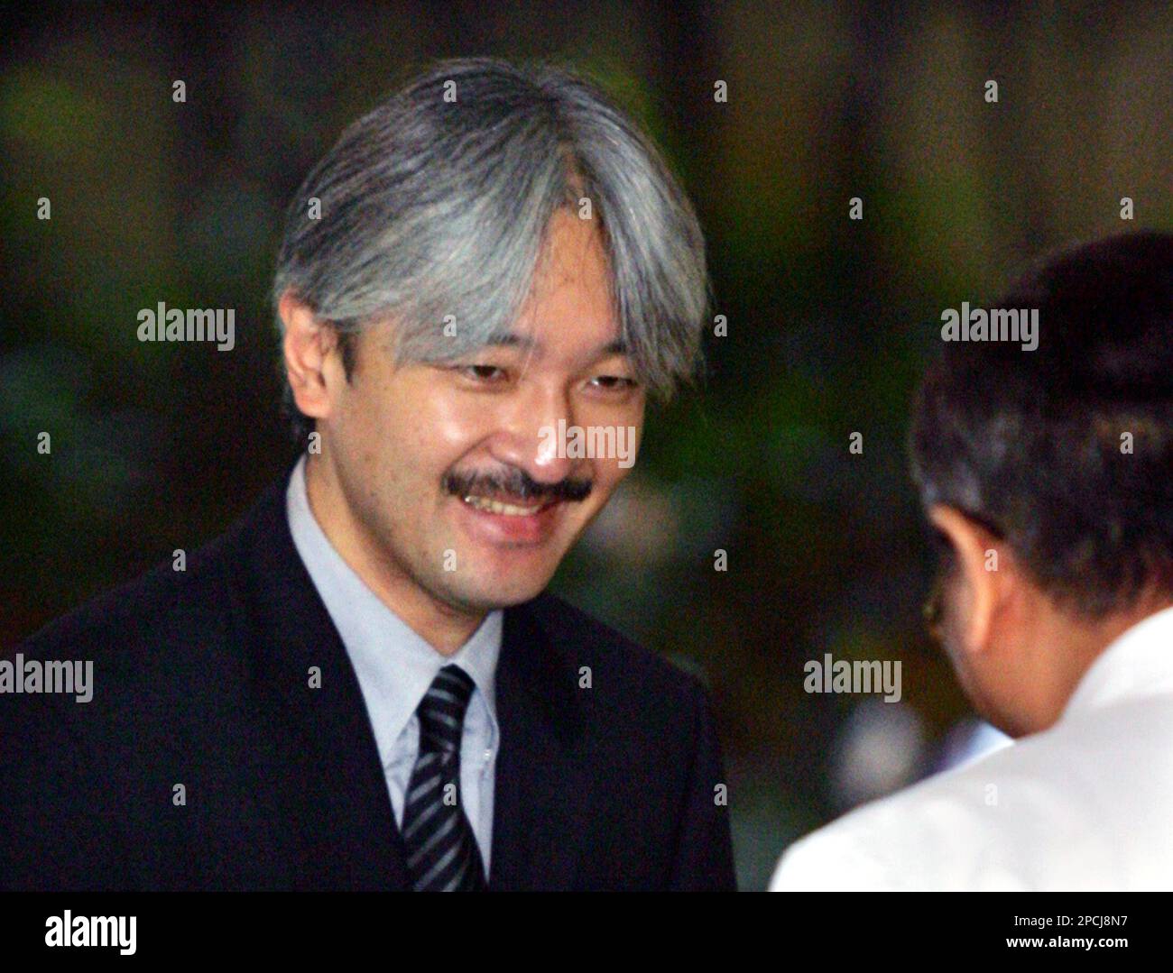 Japan's Prince Akishino, left, is greeted by Masao Nakabayashi ...