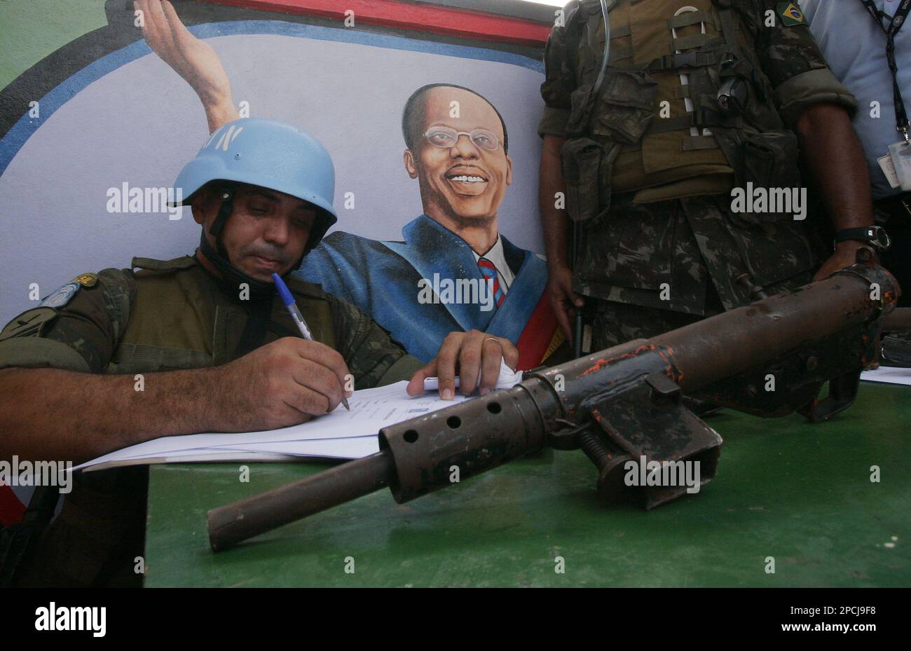 A U.N. Brazilian peacekeeper fills out documents after a gang leader ...