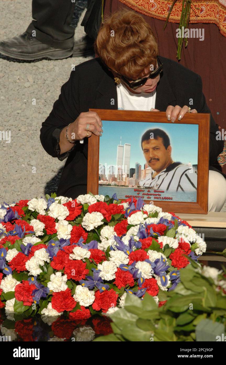 A woman displays a loved one during a commemoration ceremony for the ...