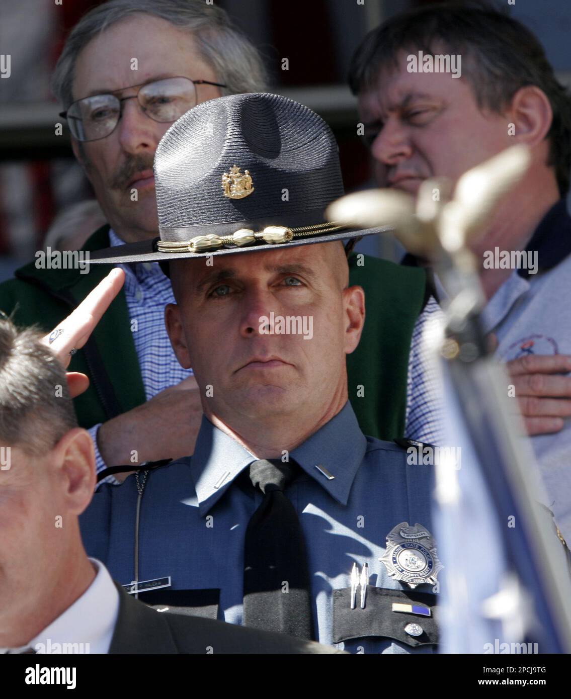 Maine State Police Lt. Gerard Madden salutes during a ceremony at the ...