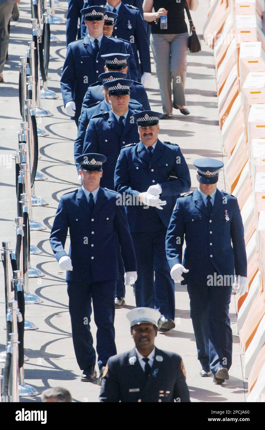 Police officers from New Zealand walk down the ramp to the reflecting ...