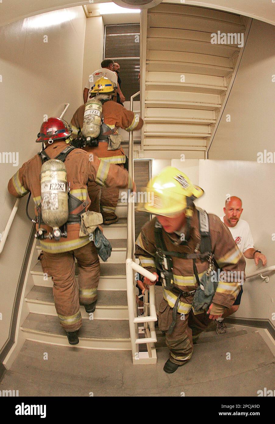 Members of various Arizona fire departments climb the stairway of Chase ...