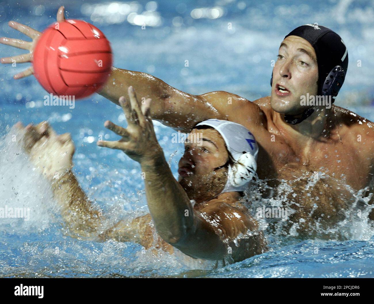 Oscar Rey, back, of Spain challenges for the ball with Cosmin Radu of ...