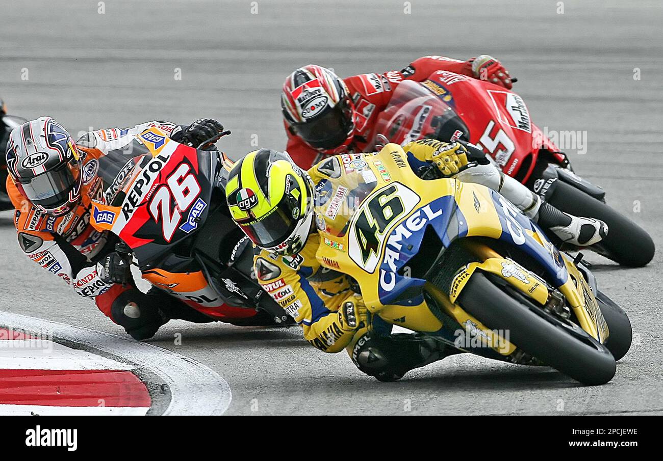Valentino Rossi from Italy, front, followed by his compatriot Loris ...