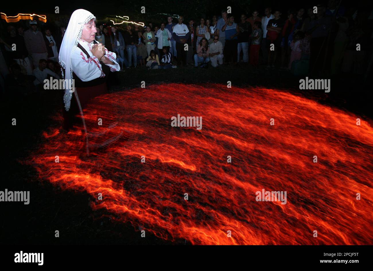 Bulgarian Nestinari dancer performs barefoot over smoldering embers as ...