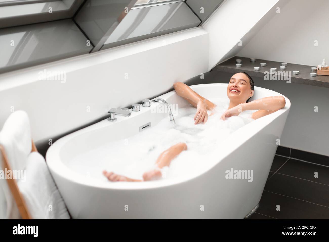 Woman Relaxing Taking Bath Lying In Water In Modern Bathroom Stock ...
