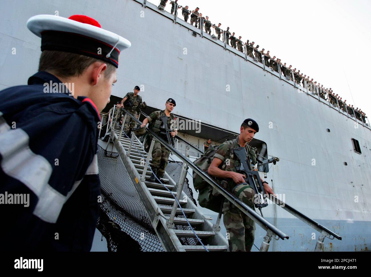 A member of the French Navy stands guard as French U.N. peacekeepers ...