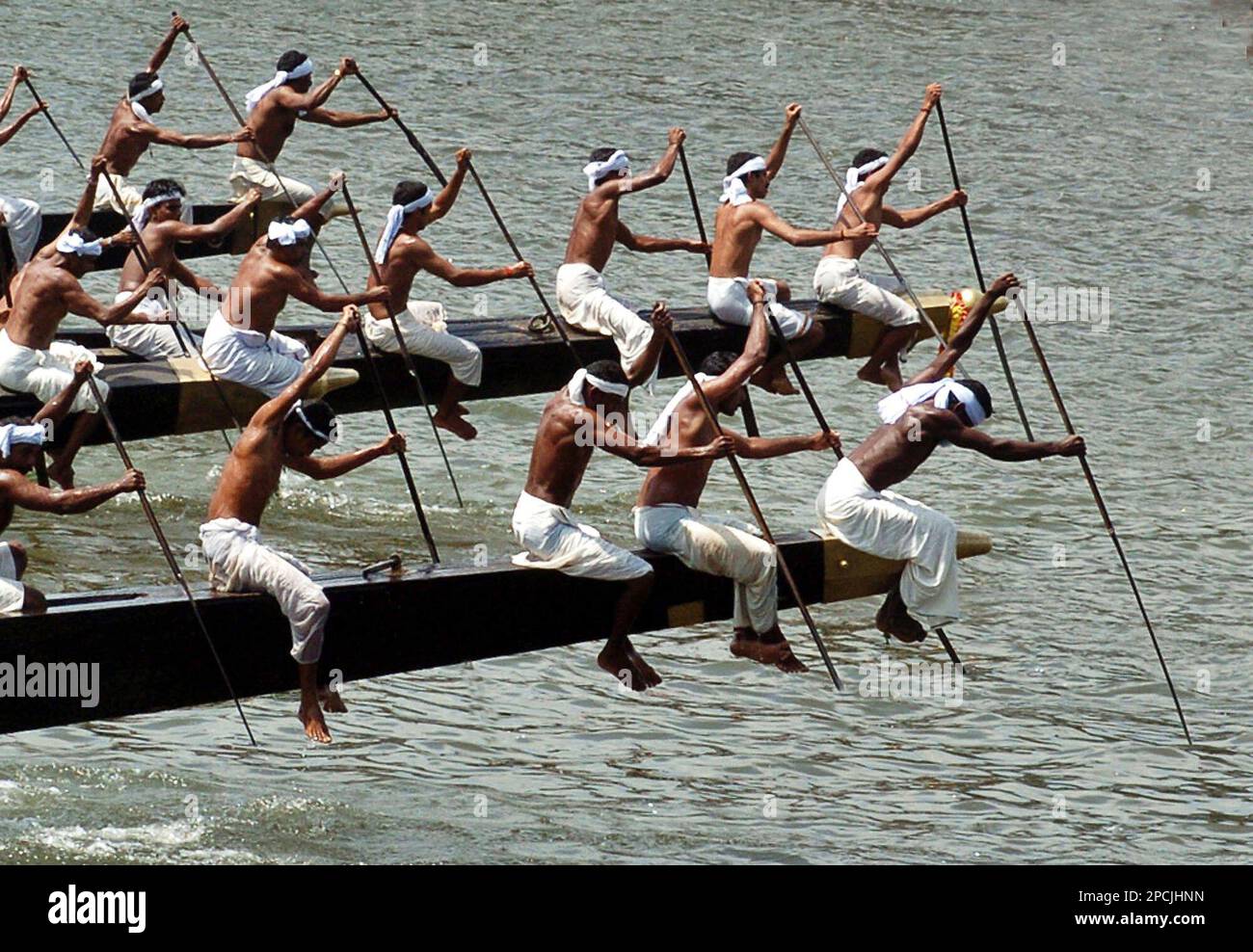 Oarsmen row their snake boats on the Pampa river during the Aranmula ...