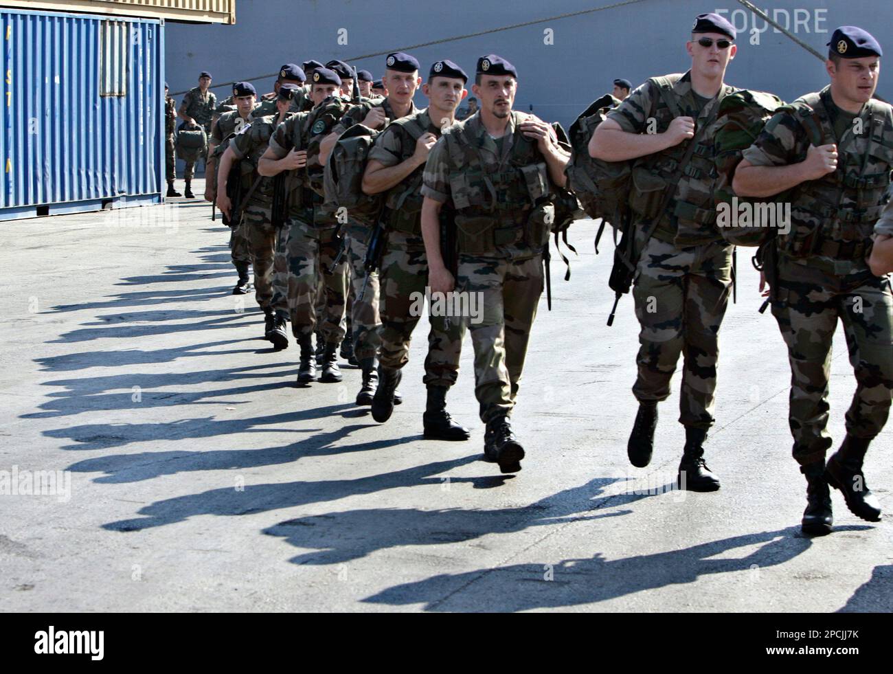 French U.N. peacekeeper walk in line as they disembark from the French ...
