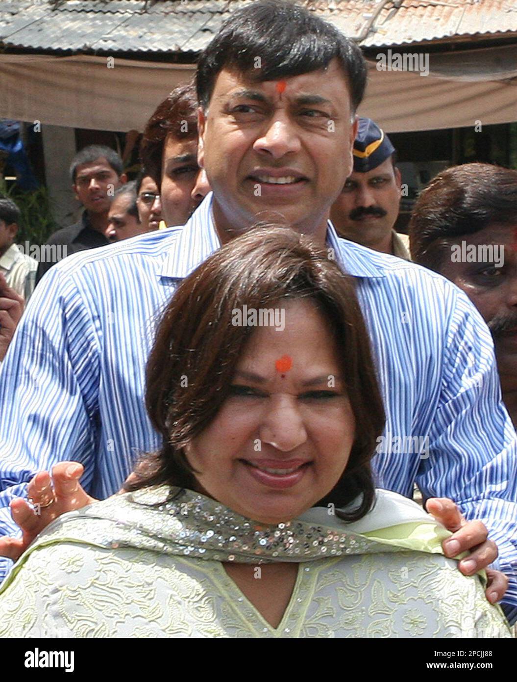 Indian-born steel tycoon Lakshmi Mittal and his wife Usha look on ...