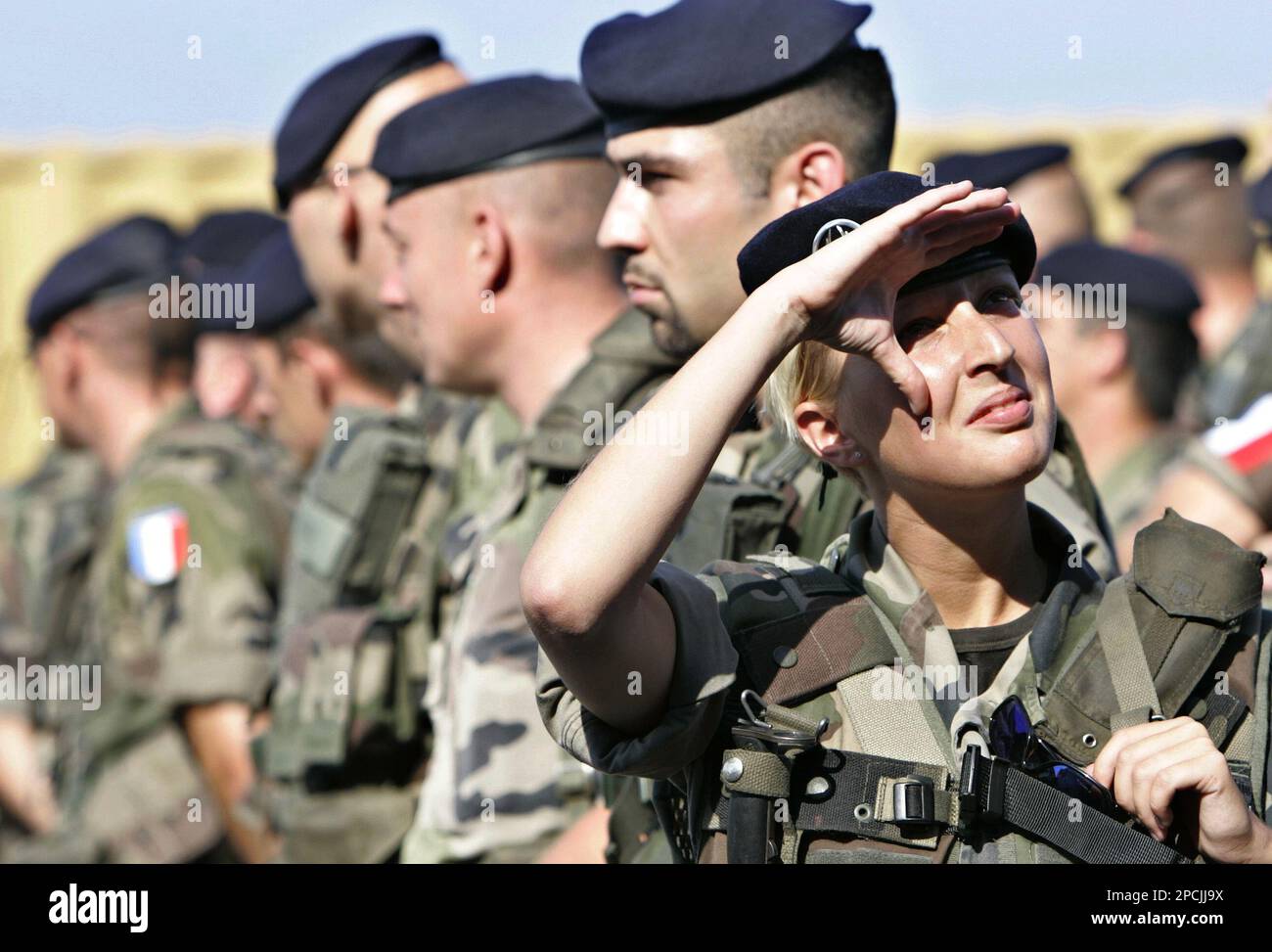 A French U.N. peacekeeper protects her eyes from the sun as she stands ...