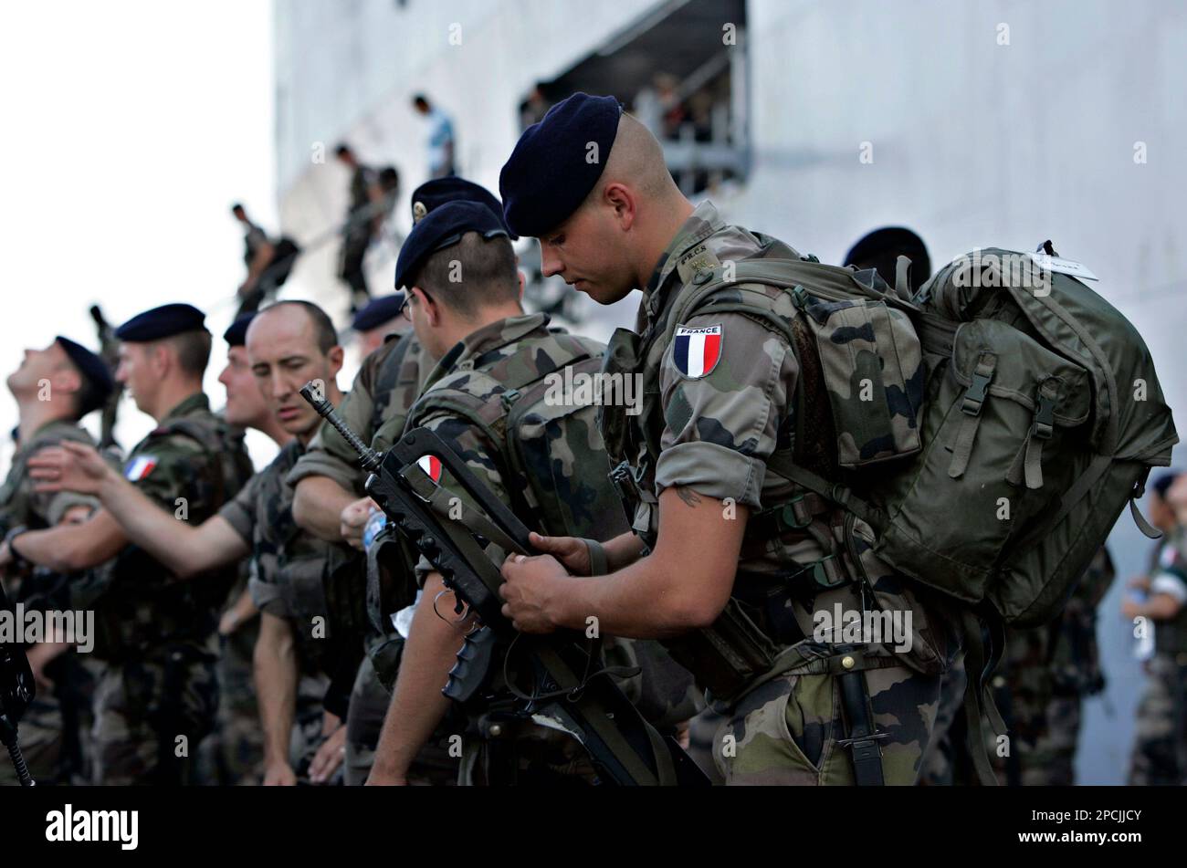 A French U.N. peacekeeper checks his automatic rifle while standing on ...