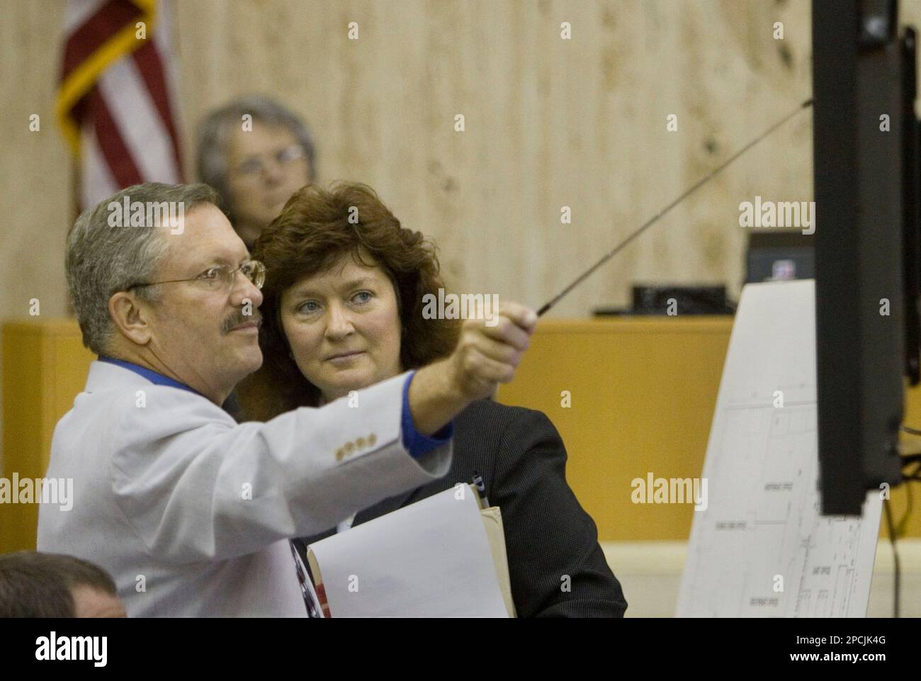 Assistant State Attorney John Aguero, left, goes over testimony from ...