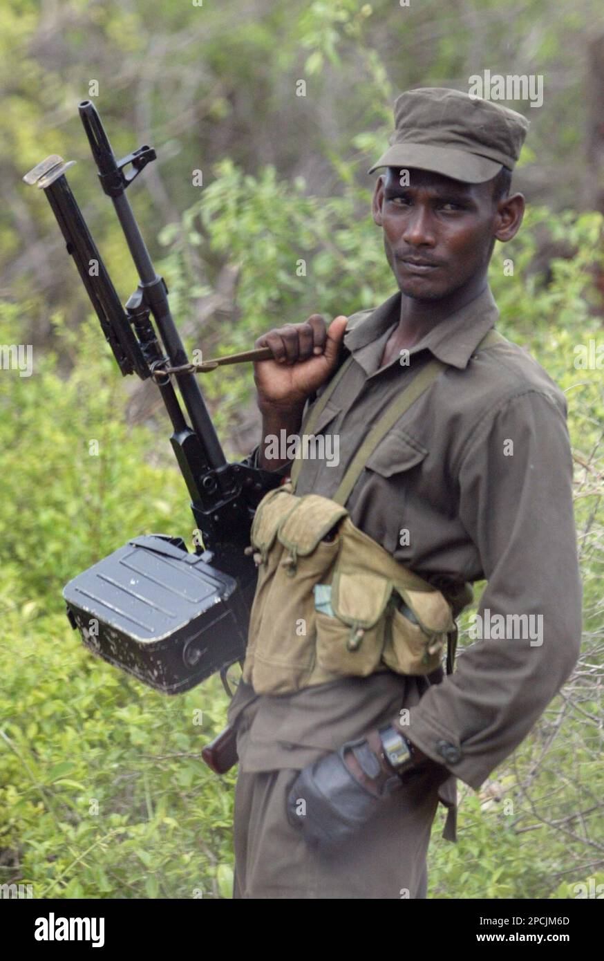 A Sri Lankan army soldier patrols in newly captured area of Sampur 220 ...