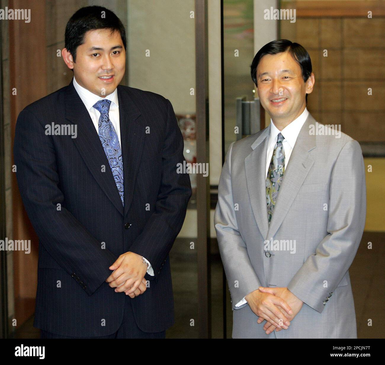 Brunei's Prince Abdul Qawi, left, is greeted by Japanese Crown Prince ...