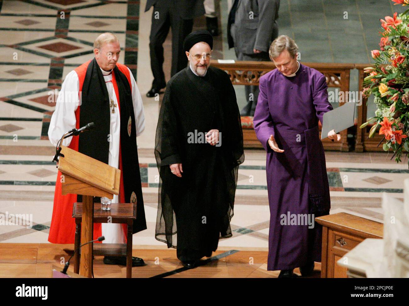 Former Iranian President Mohammad Khatami, center, is escorted by Rev ...