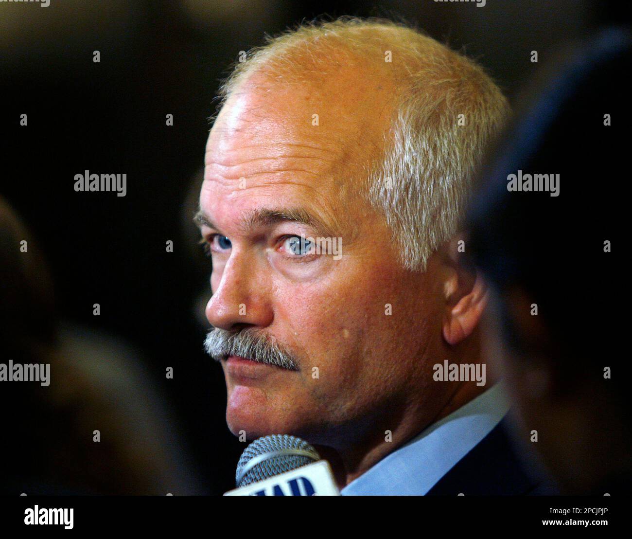 Federal NDP Leader Jack Layton speaks to reporters during a break in ...