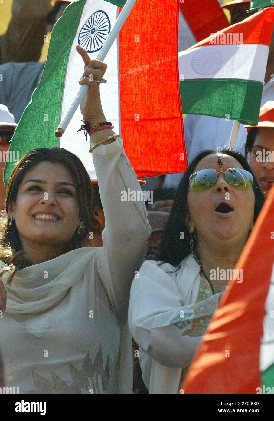Bollywood actress Raveena Tandon, left, hold the Indian national flag ...