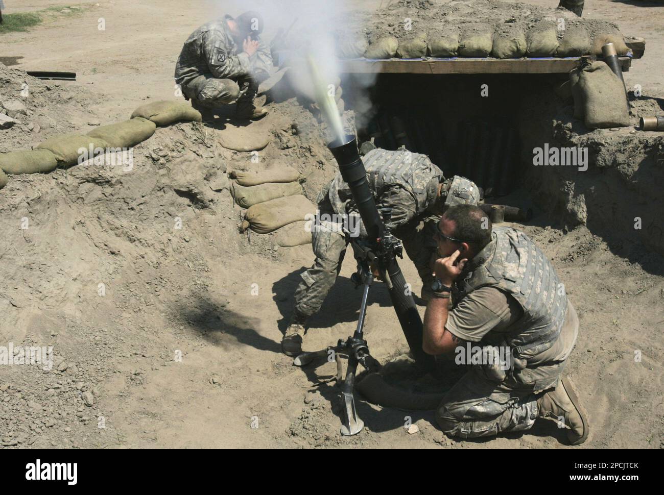 Specialist Chris Milam of Duncan, Oklahoma, right, fires an 81 mm ...
