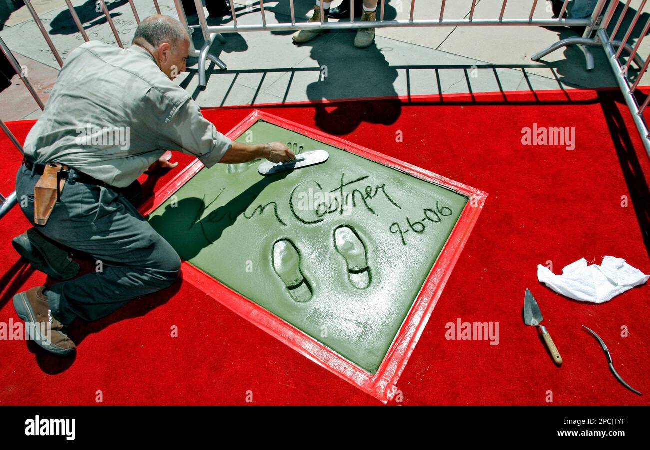 Sassan Shakoori a worker at Grauman's Chinese Theatre, smooths out ...