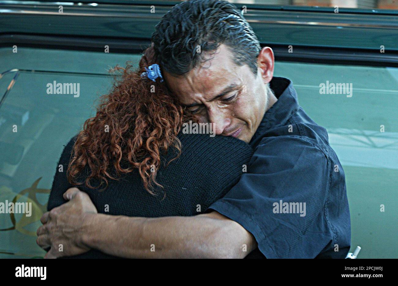 Relatives of Aurora Restrepo cry after receiving her body at Bogota's ...