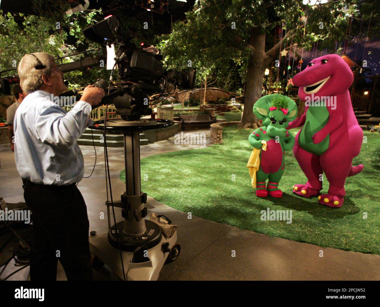 ** ADVANCE FOR WEEKEND, SEPT 9-10 ** Cameraman John Thomas, left, tapes dinosaur characters Baby ...