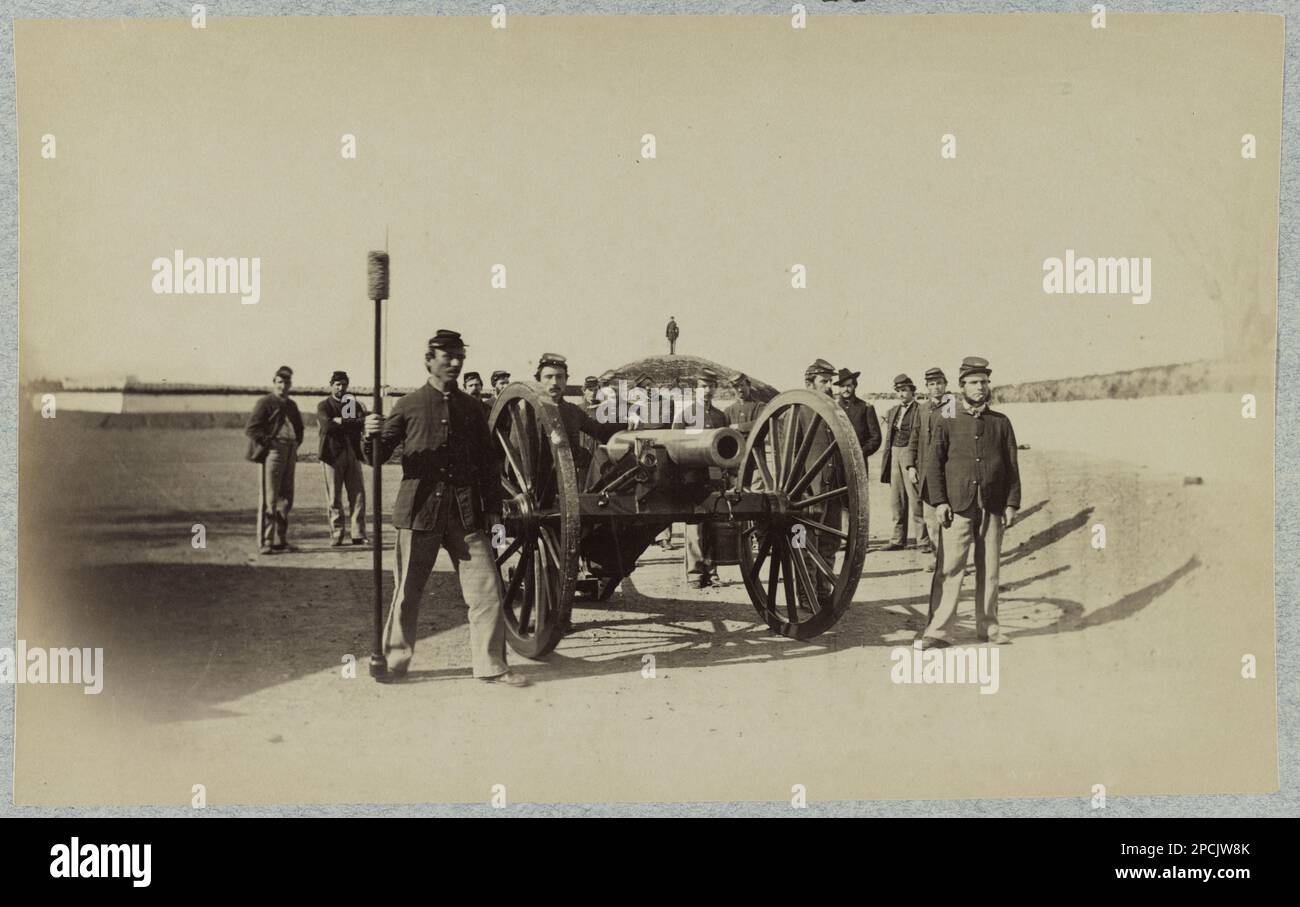 Union soldiers stand around a mounted cannon at a fort. Title devised ...