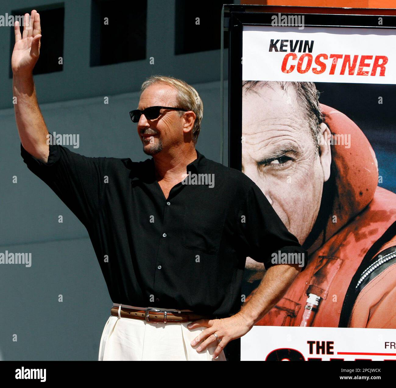 Actor/director Kevin Costner waves before having his hand and feet ...
