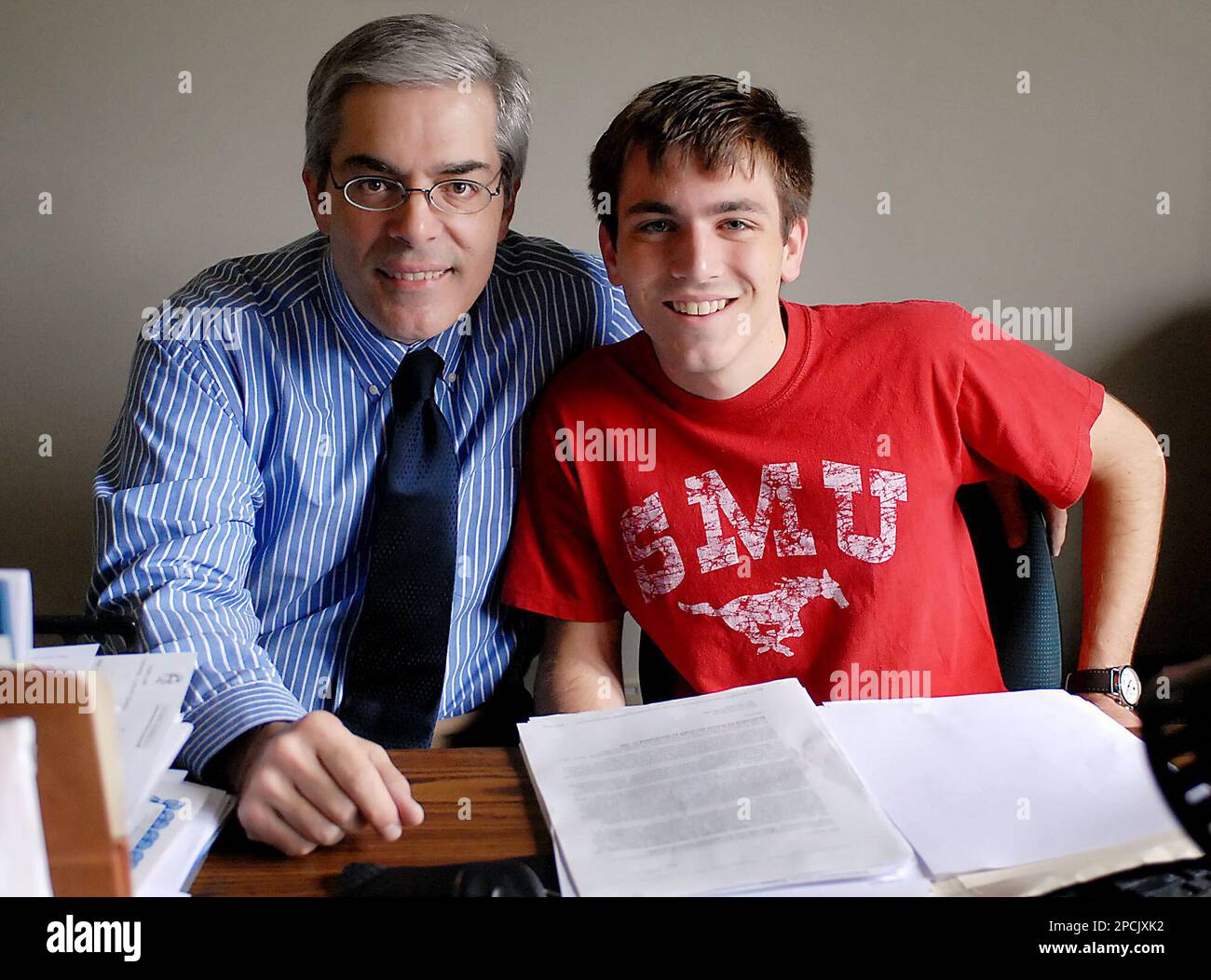 Chris Economou, left, a financial planner, goes over college paperwork ...