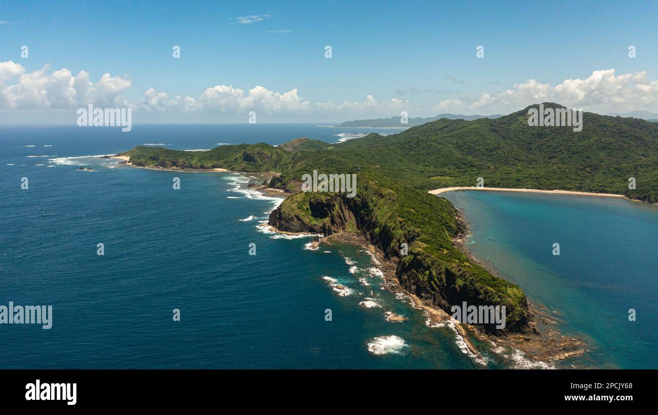 The coast of the island with beaches and rainforest. Cape Engano ...