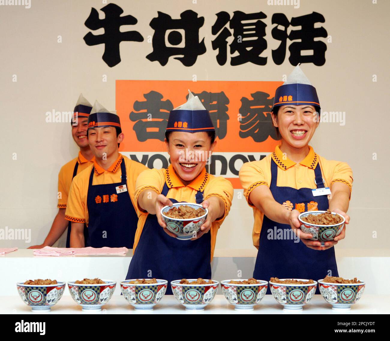 Employees of Yoshinoya D&C Co., serve the rice dish topped with ...