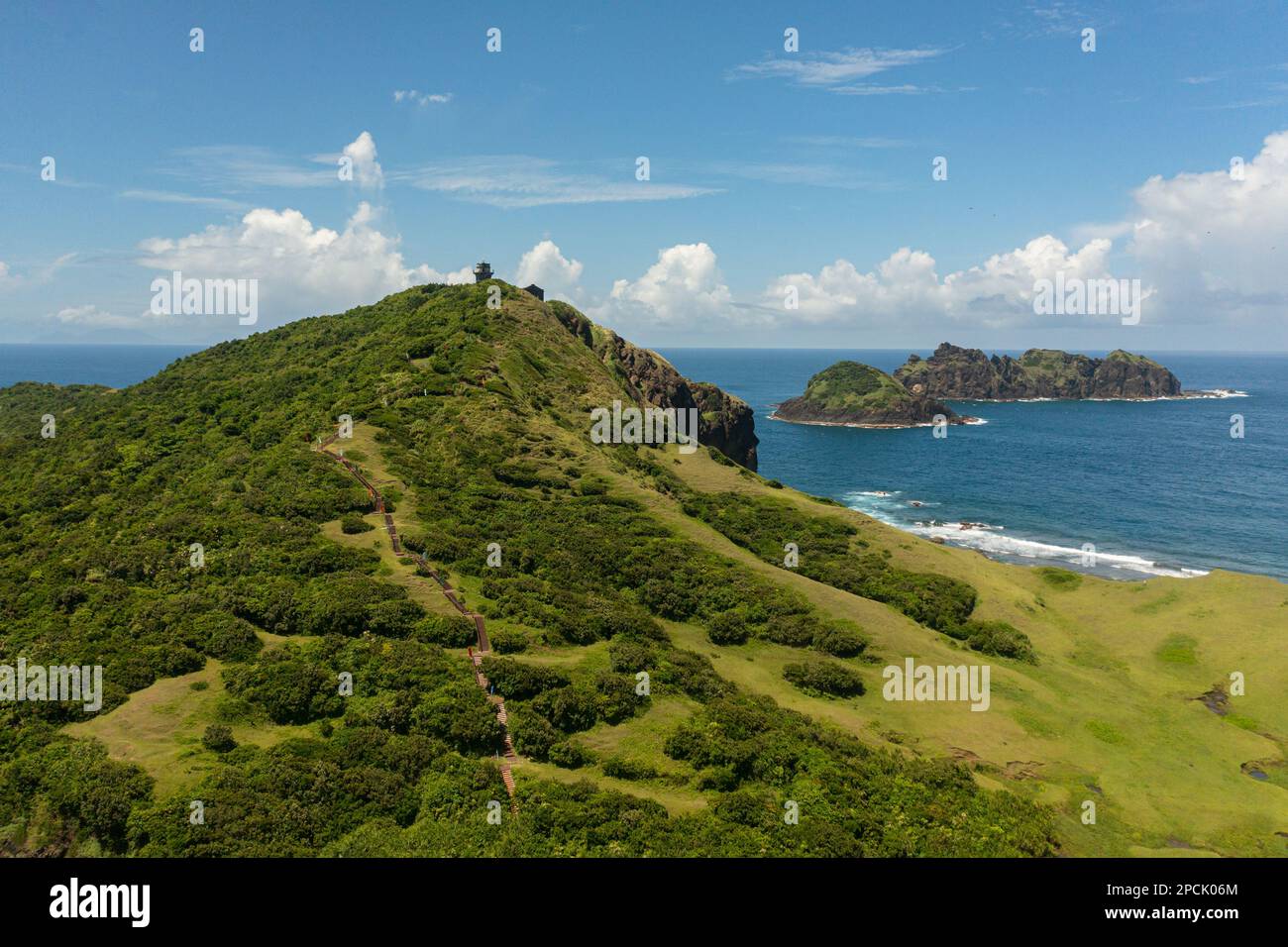 Lighthouse and tropical islands on the background of the blue ocean ...
