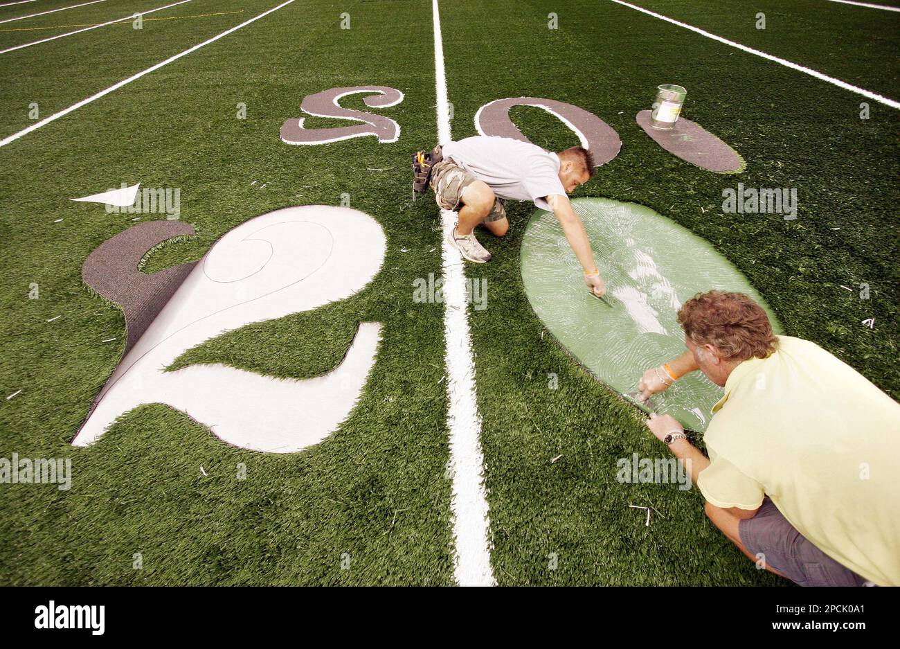 Jeff Foss, left, and Curtis McDougal, both from Sportexe work to ...
