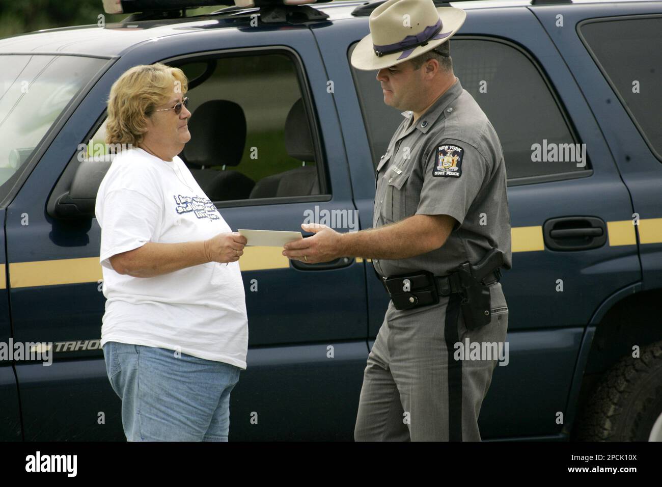 New York State Trooper Snell accepts a sympathy card on behalf of the ...