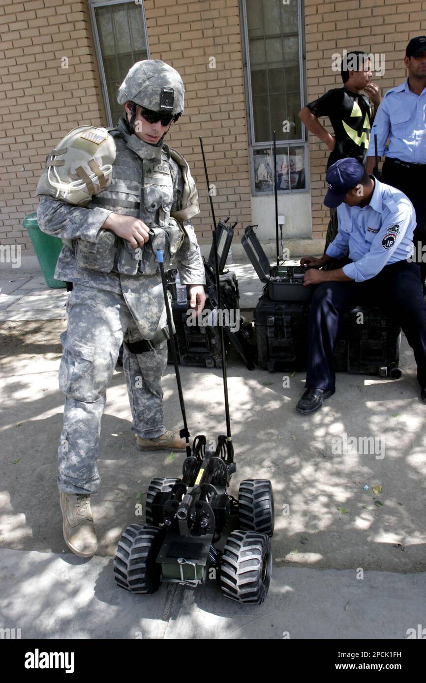 A U.S. soldier checks an improvise explosive device detection robot as ...