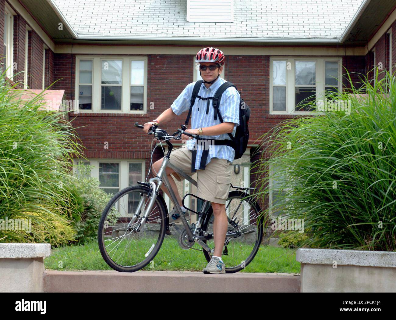Bruce Wilbur poses for a portrait with his bicycle outside the ...