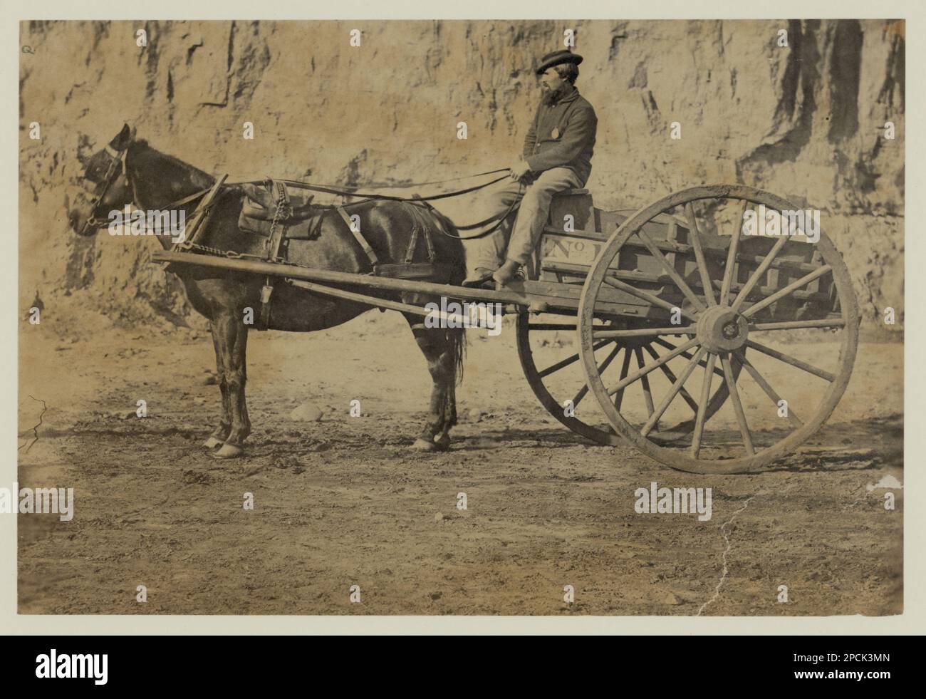 Man sitting in a horse drawn cart. Title devised by Library staff ...