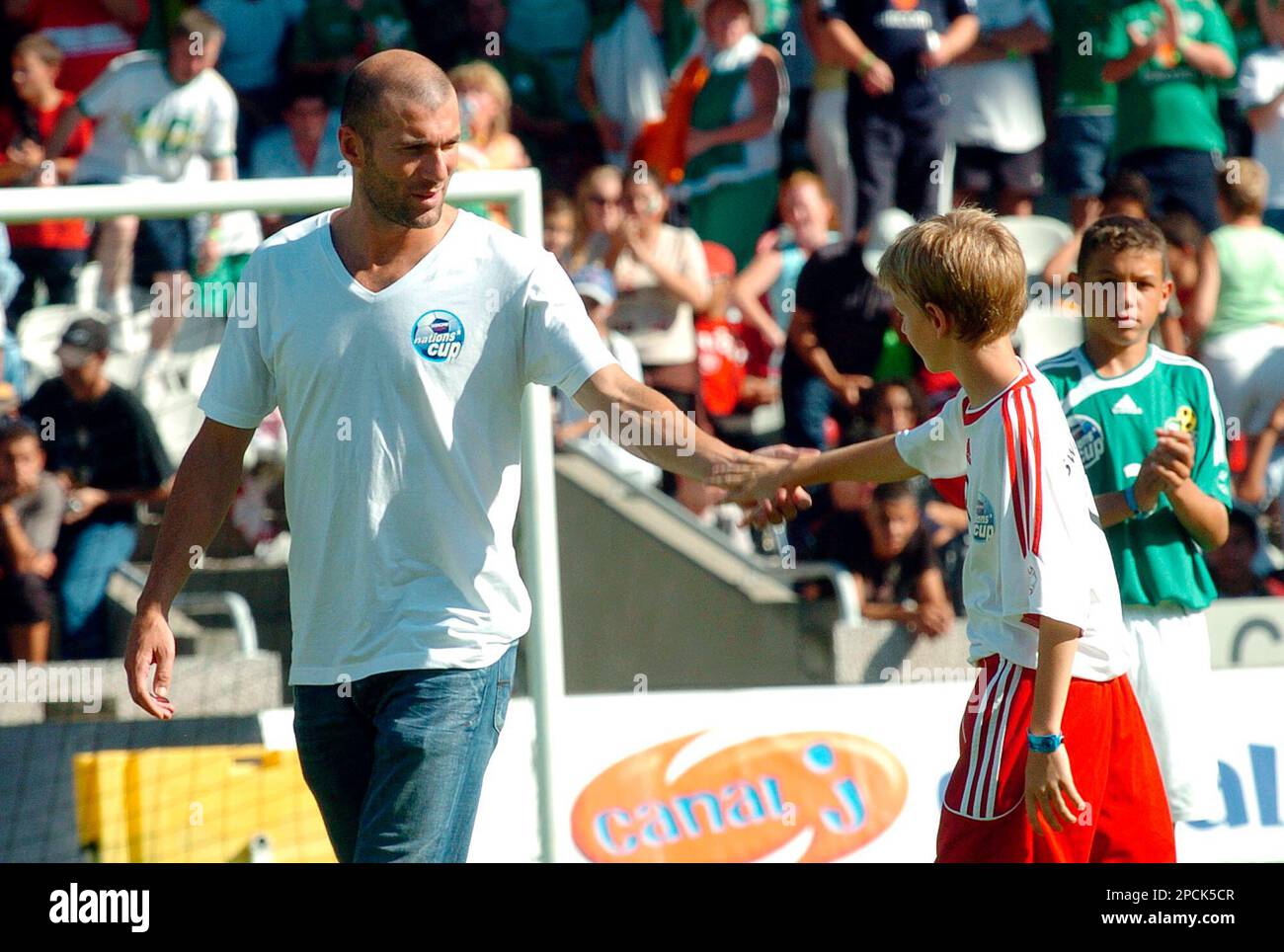 Zinedine Zidane shakes hands with fans during the Danone Nations Cup ...