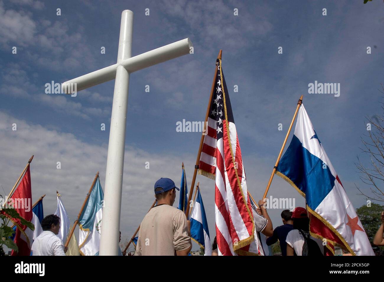 Central American migrant supporters carry a flags from the Americas ...