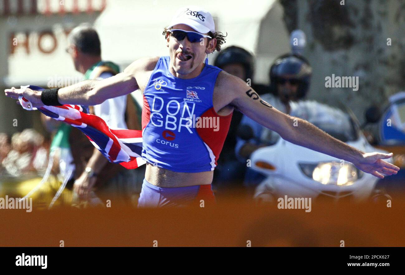 Tim Don of Britain celebrates as he crosses the finish line to win the ...
