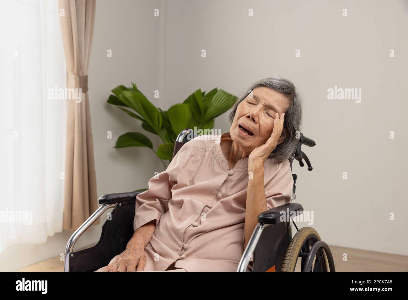 Asian elderly woman sit asleep, snooze on wheelchair at nursing home ...