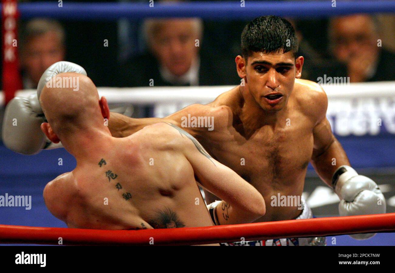 British boxer Amir Khan, right, throws a punch at Ryan Barrett, during ...