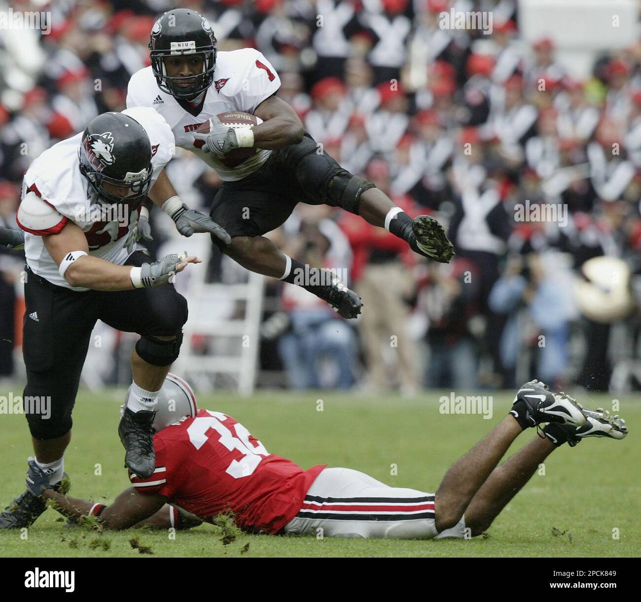 Northern Illinois' Garrett Wolfe, top, jumps over Ohio State's Brandon ...