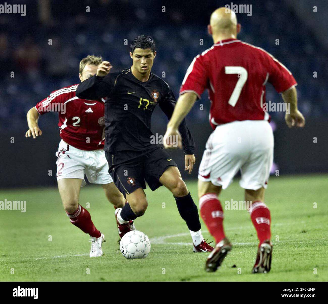 Portugal's Cristiano Ronaldo, center, takes the ball between Denmarks ...