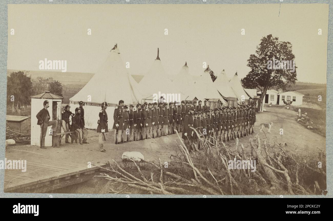 Union soldiers lined up in two rows in front of tents. Title devised by ...